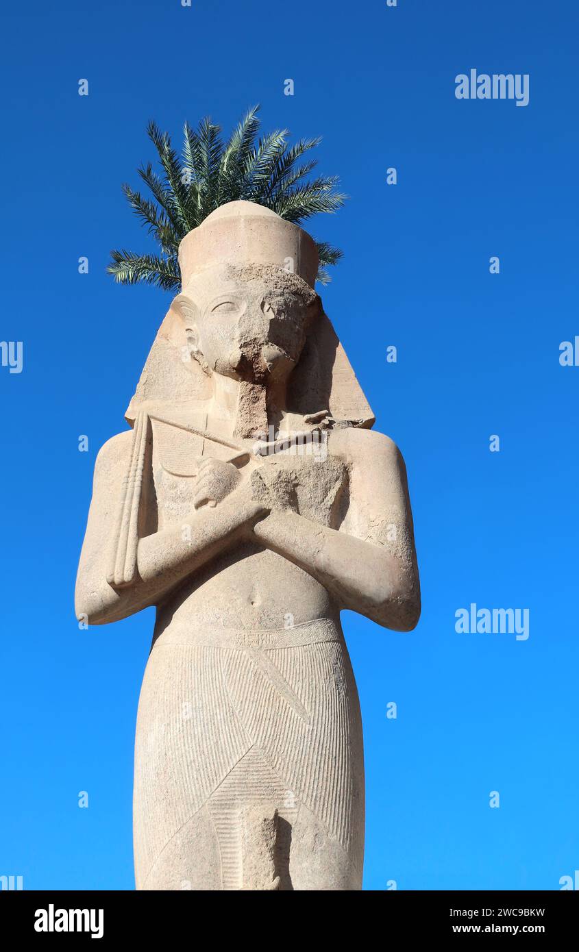 Pharaoh statue on blue sky background, Karnak Temple, Luxor. Ancient ... Pharaoh statue on blue sky background, Karnak Temple, Luxor. Ancient ...