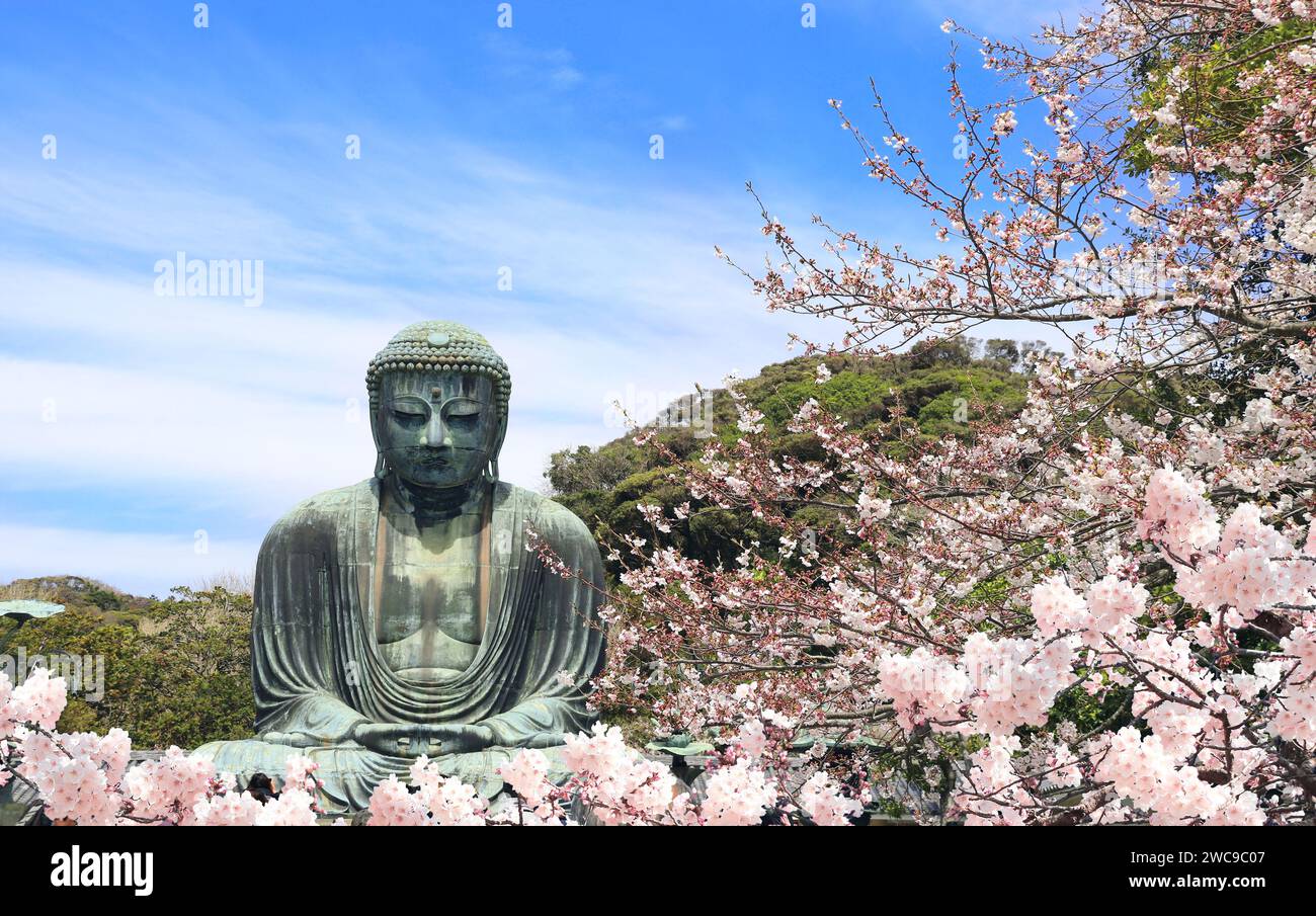 Ancient bronze statue of the Great Buddha Daibutsu and flowers of ...