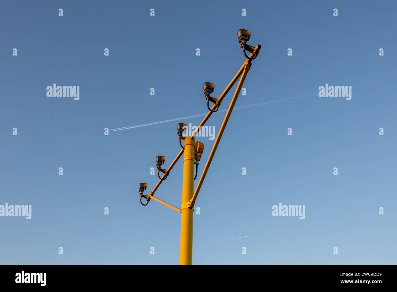 A tall electrical power pole against a vibrant blue sky Stock Photo - Alamy