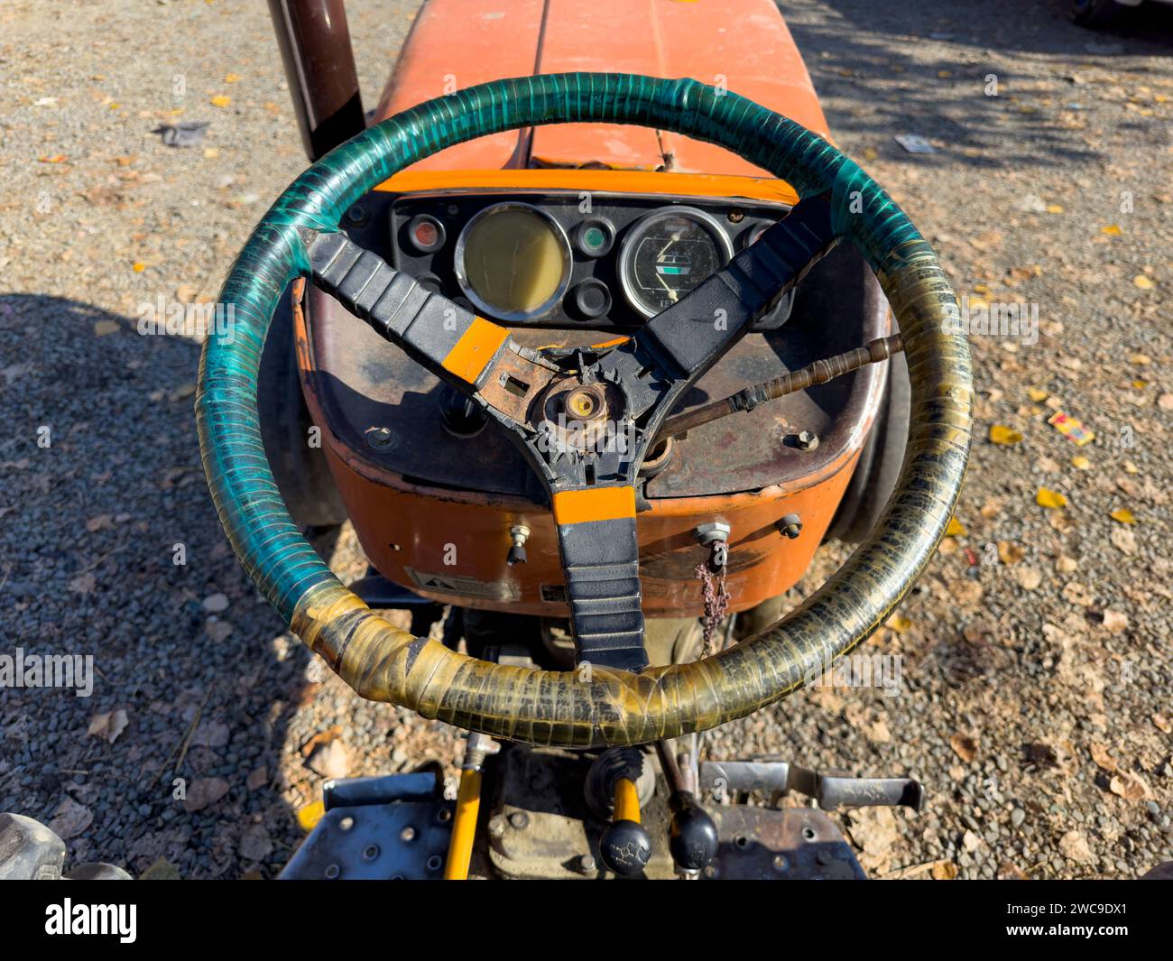 An old tractor steering wheel closeup Stock Photo - Alamy