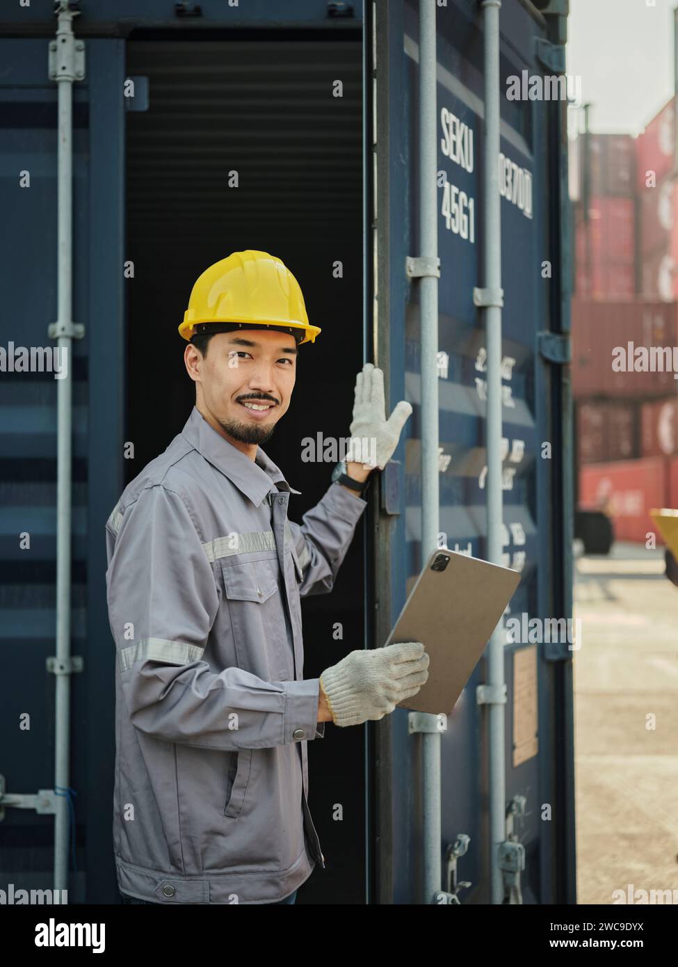 Portrait of young Asian worker wearing safety helmet and holding ...