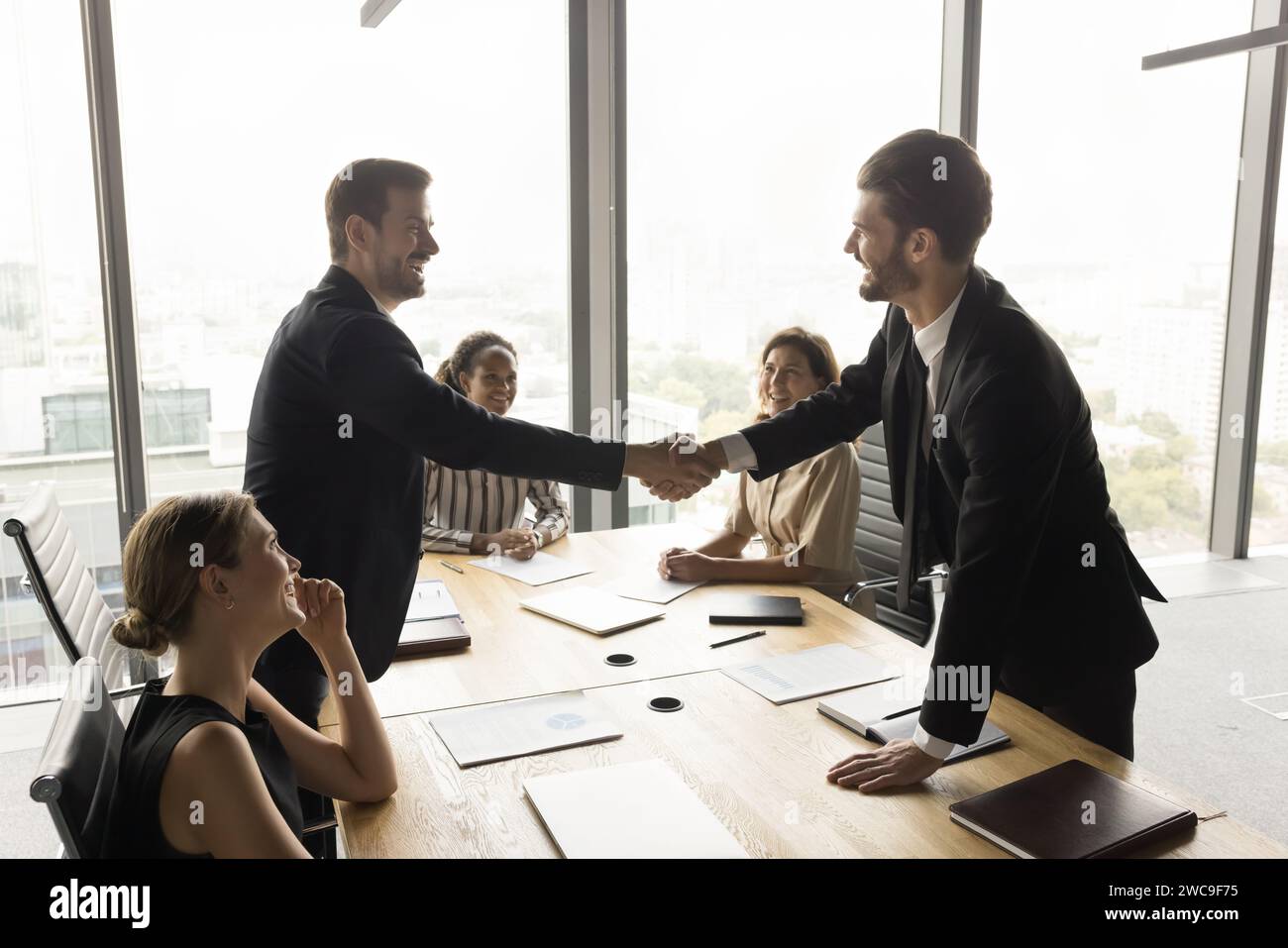 Happy successful business men celebrating cooperation, successful ...
