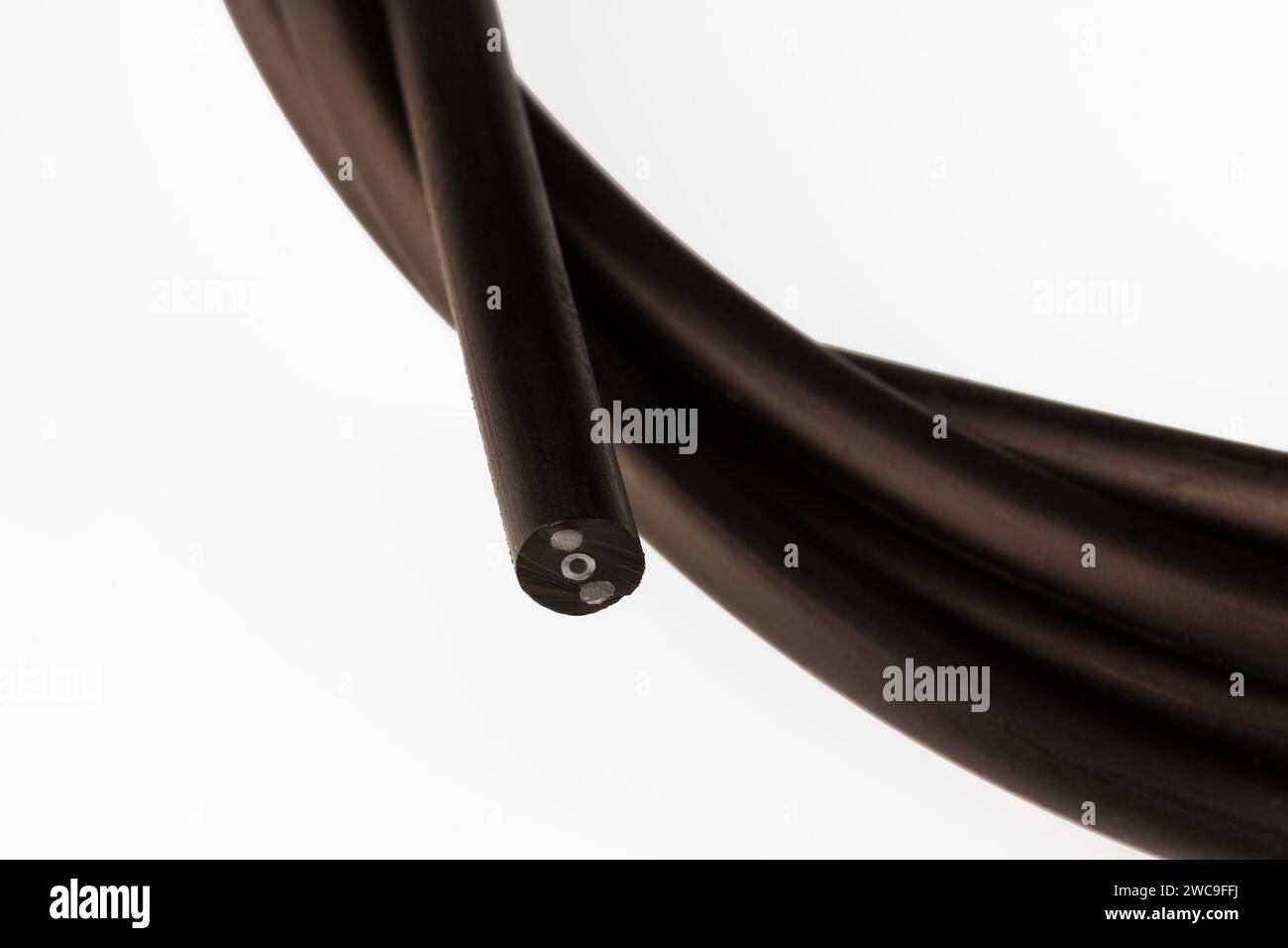 black fiber optic cable for internet connection on a white background ...
