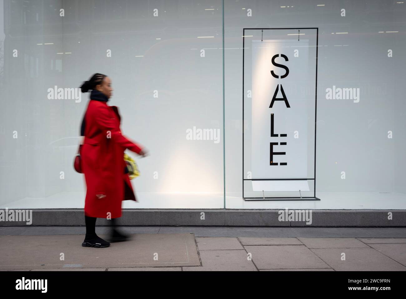 A shopper blurs past a generic shop business whose January Sales are ...