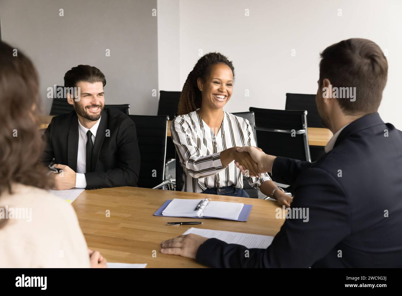 Male boss giving handshake to best manager woman Stock Photo - Alamy
