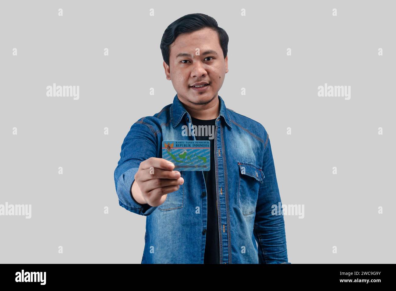 Young Asian Man showing the Indonesia identity card or KTP isolated ...