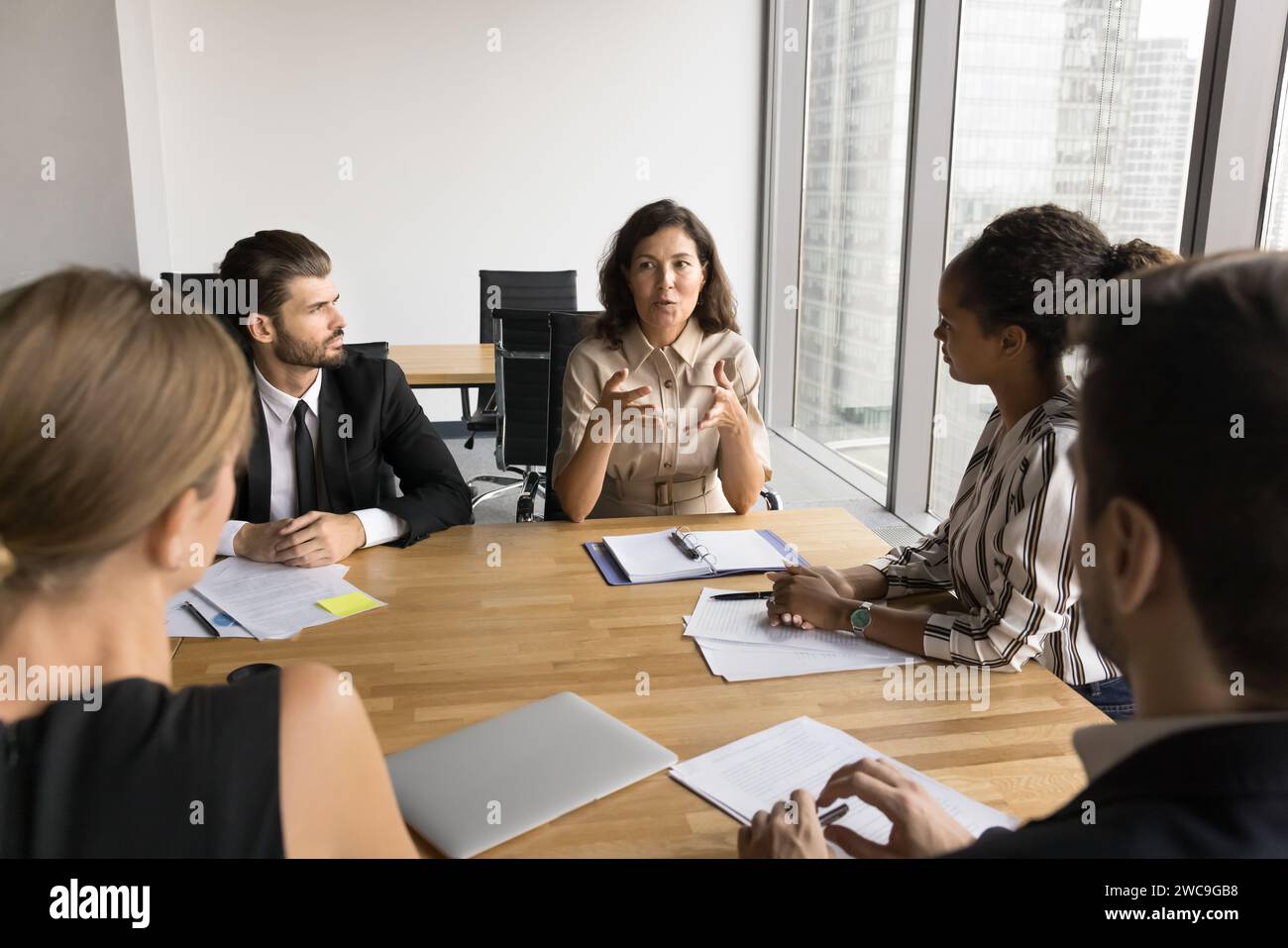 Middle aged business professional offering ideas for project management ...