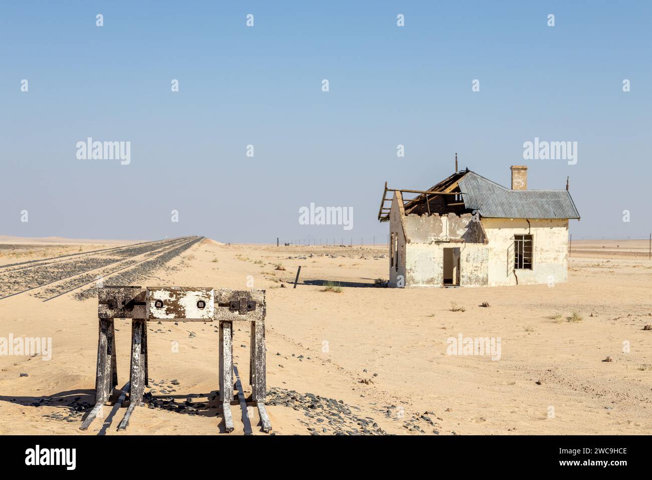 An old structure stands desolately in the arid desert, surrounded by ...