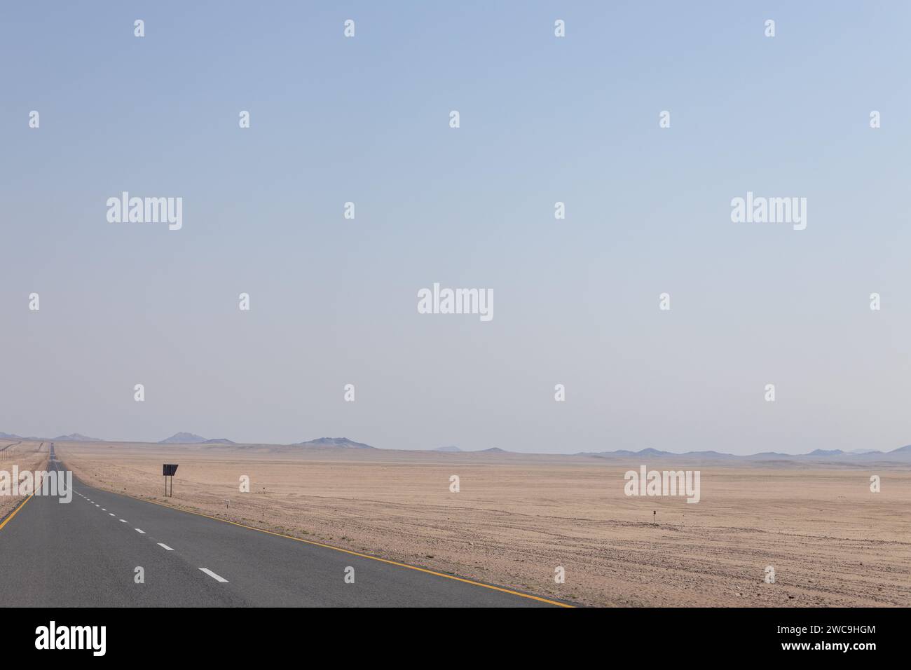 An isolated road winds through a vast desert landscape Stock Photo - Alamy