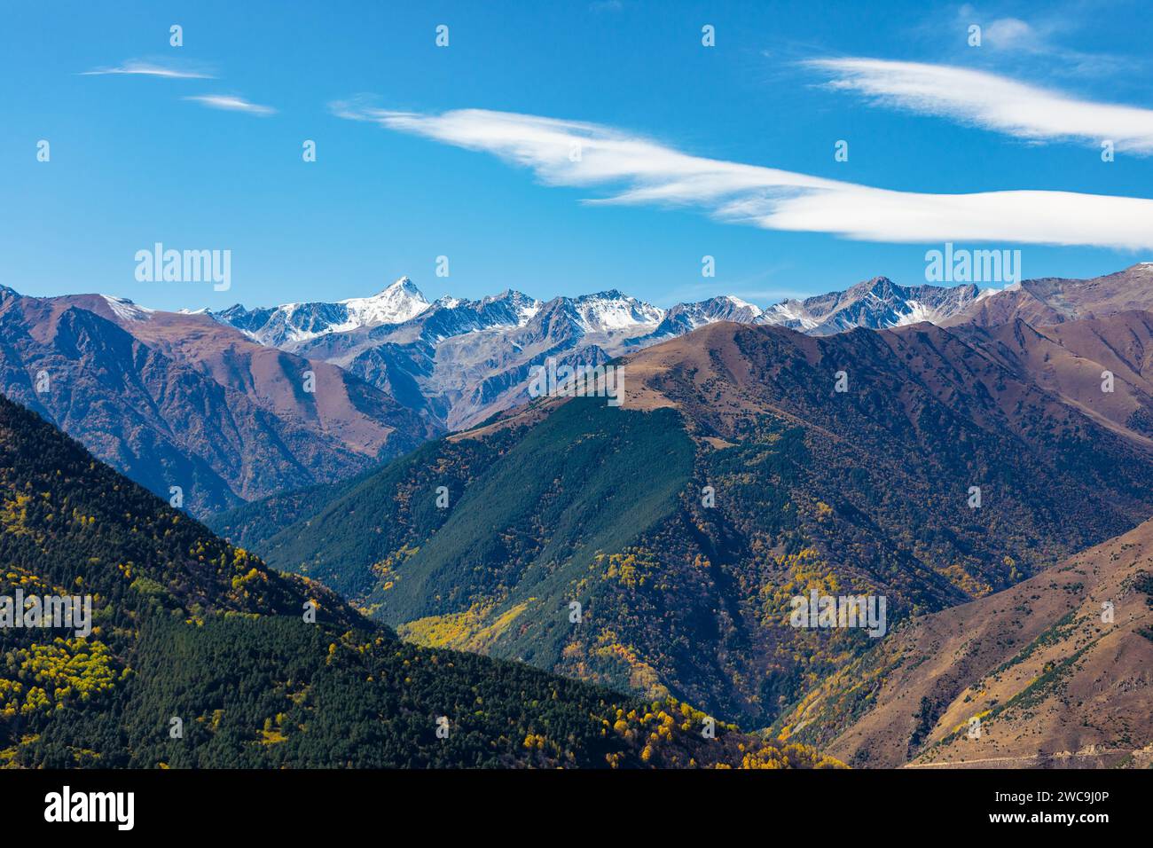 Beautiful panoramic view of snow-capped mountains shrouded in a soft ...