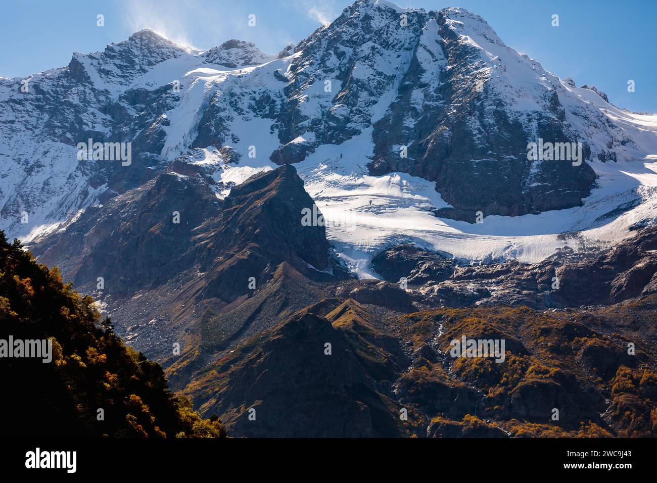 Beautiful panoramic view of snow-capped mountains shrouded in a soft ...