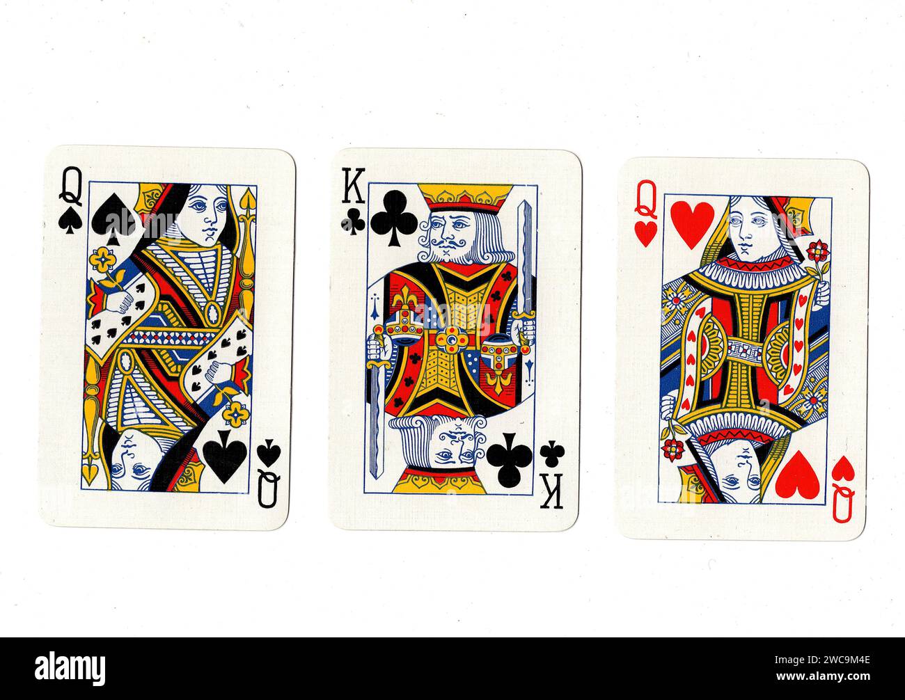 Vintage playing cards showing a pair of queens and a king isolated on a ...