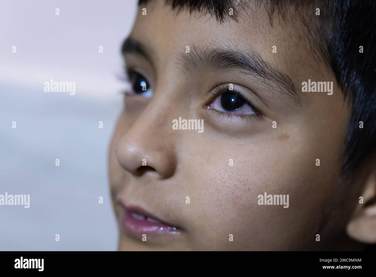 young kid red eye after playing online games at night with blurred ...