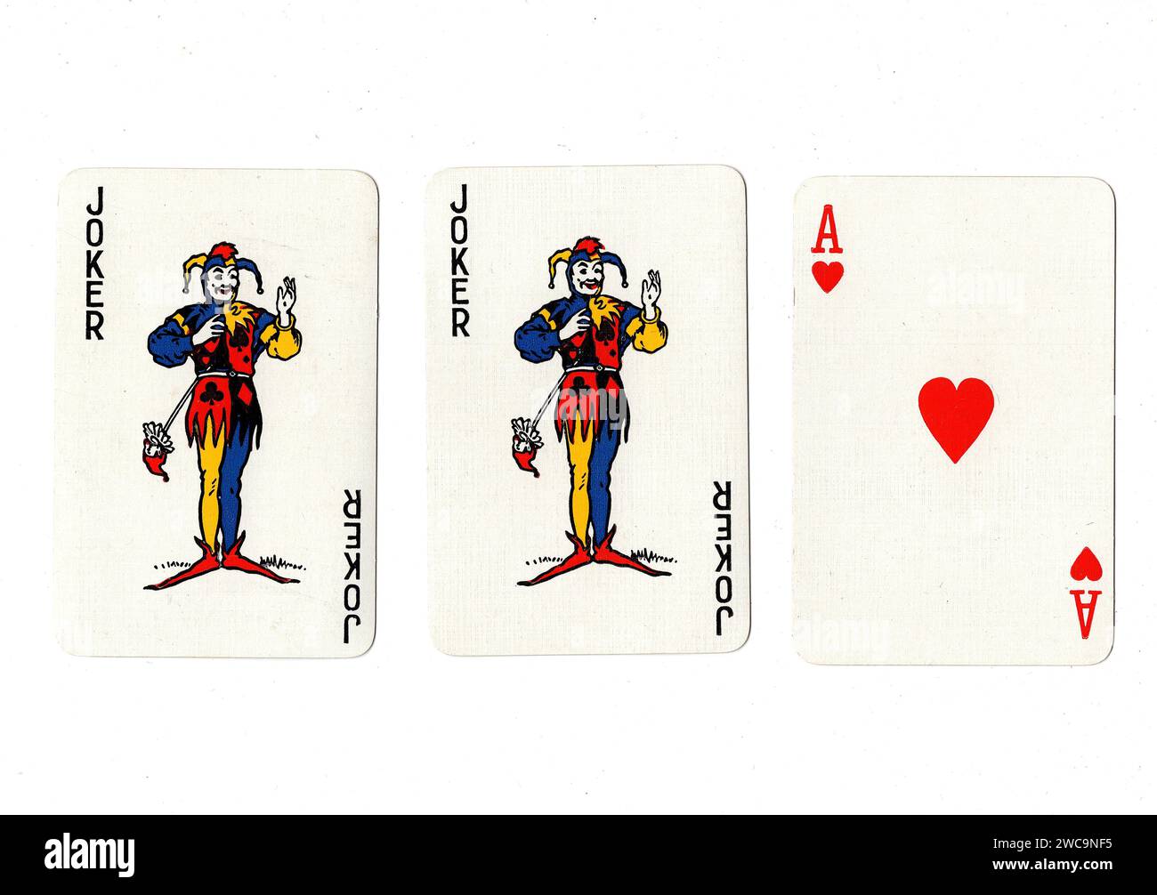 Vintage playing cards showing a pair of jokers and a red ace isolated ...