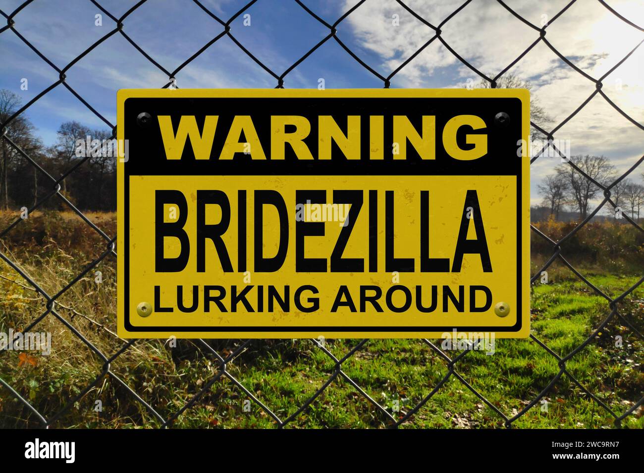 Black and yellow warning sign on a fence with the message "Warning ...