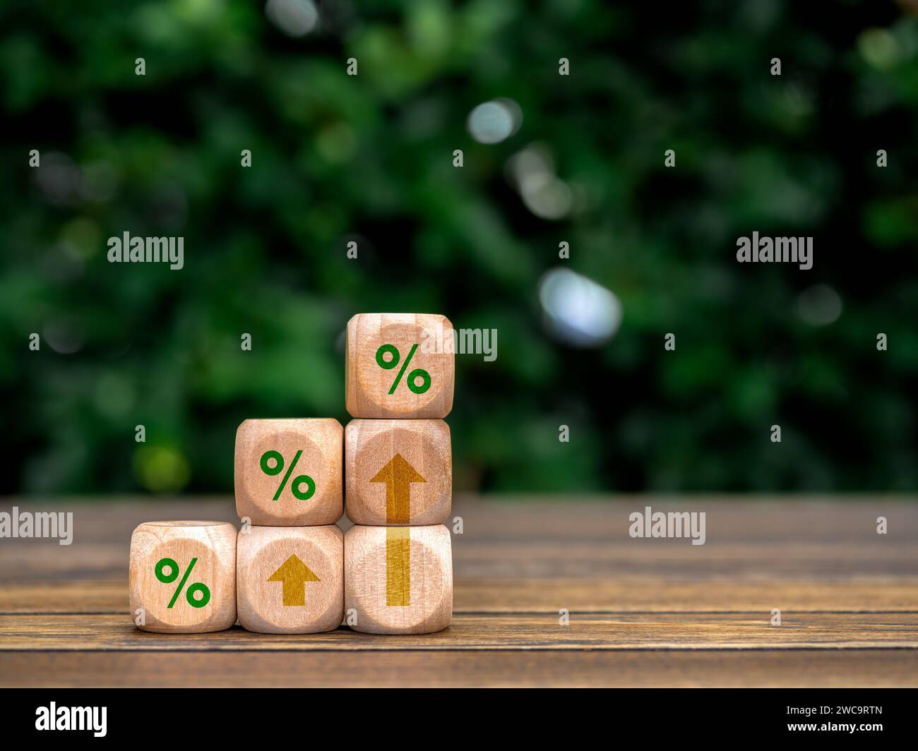 Green percentage and rise up arrows on wooden cube blocks as a business ...