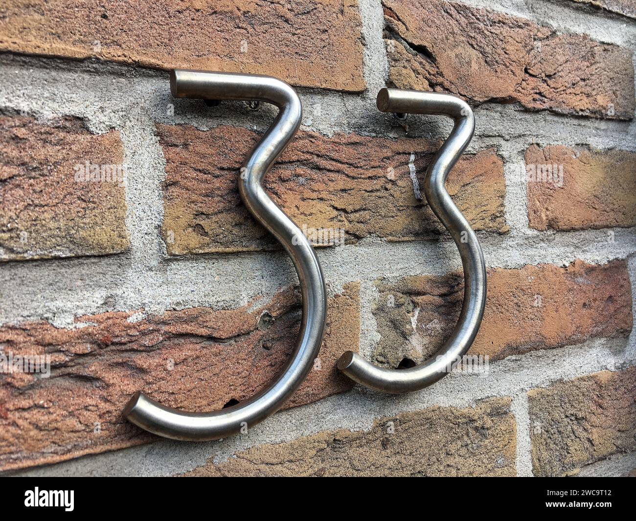 Close up of an house door number 33 Stock Photo - Alamy