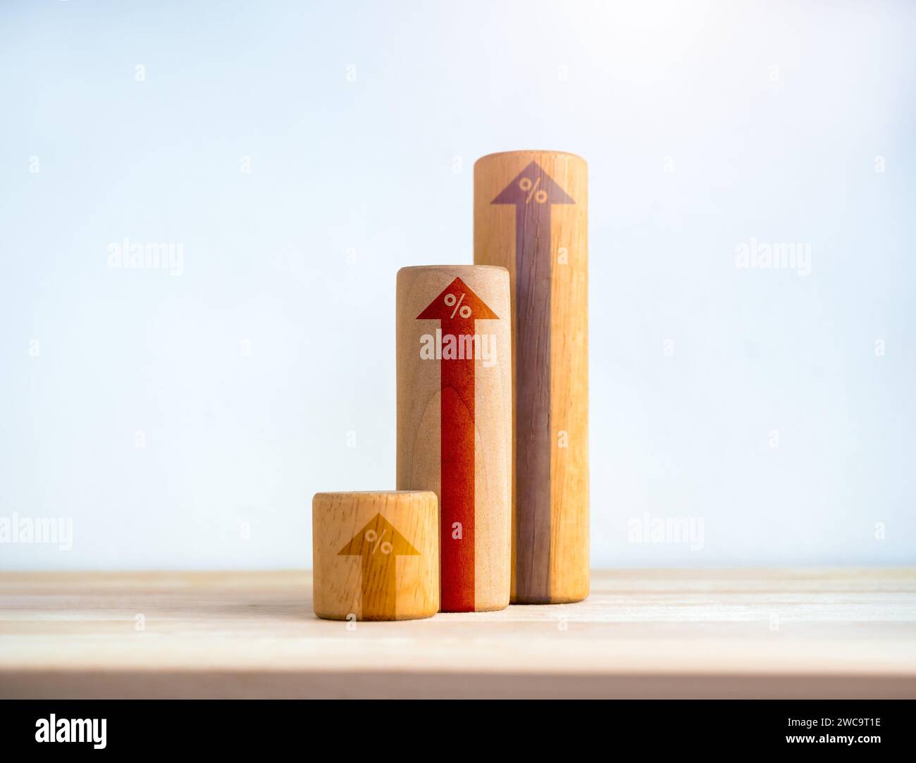 Rising up arrows on round wooden sticks as business graph steps ...