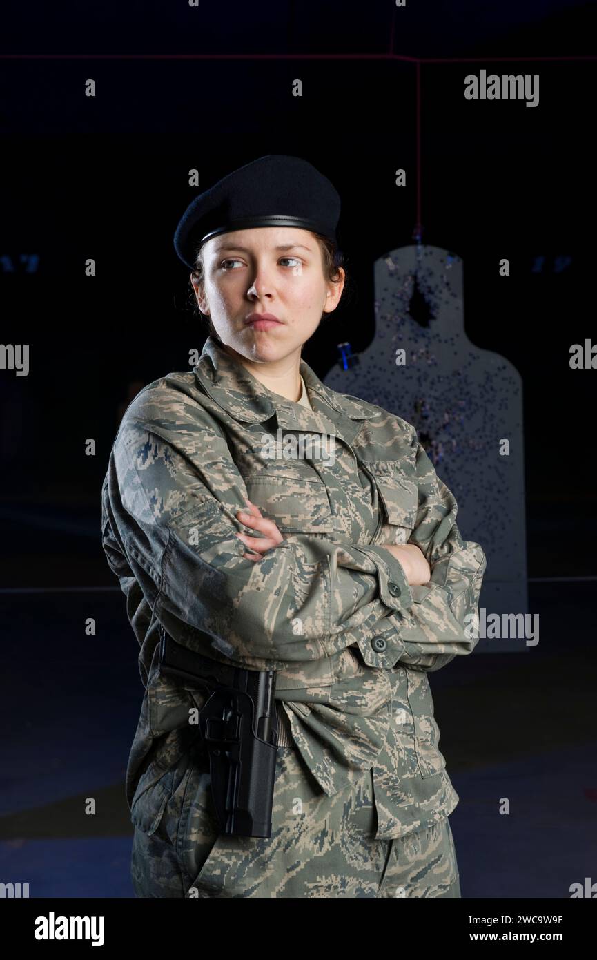 A female military police officer prepares to draw her pistol at the ...