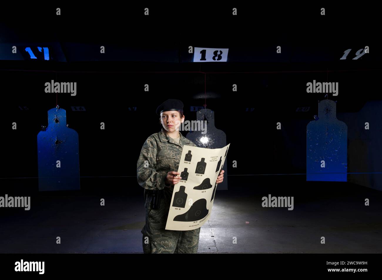 A female military police officer prepares to draw her pistol at the ...