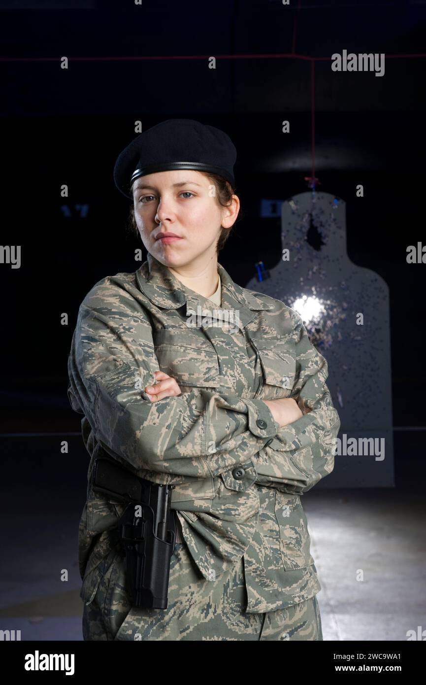 A female military police officer prepares to draw her pistol at the ...