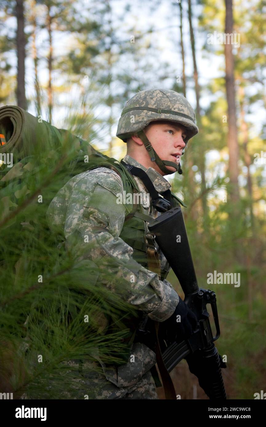 A soldier patrols through the woods during a field training exercise ...