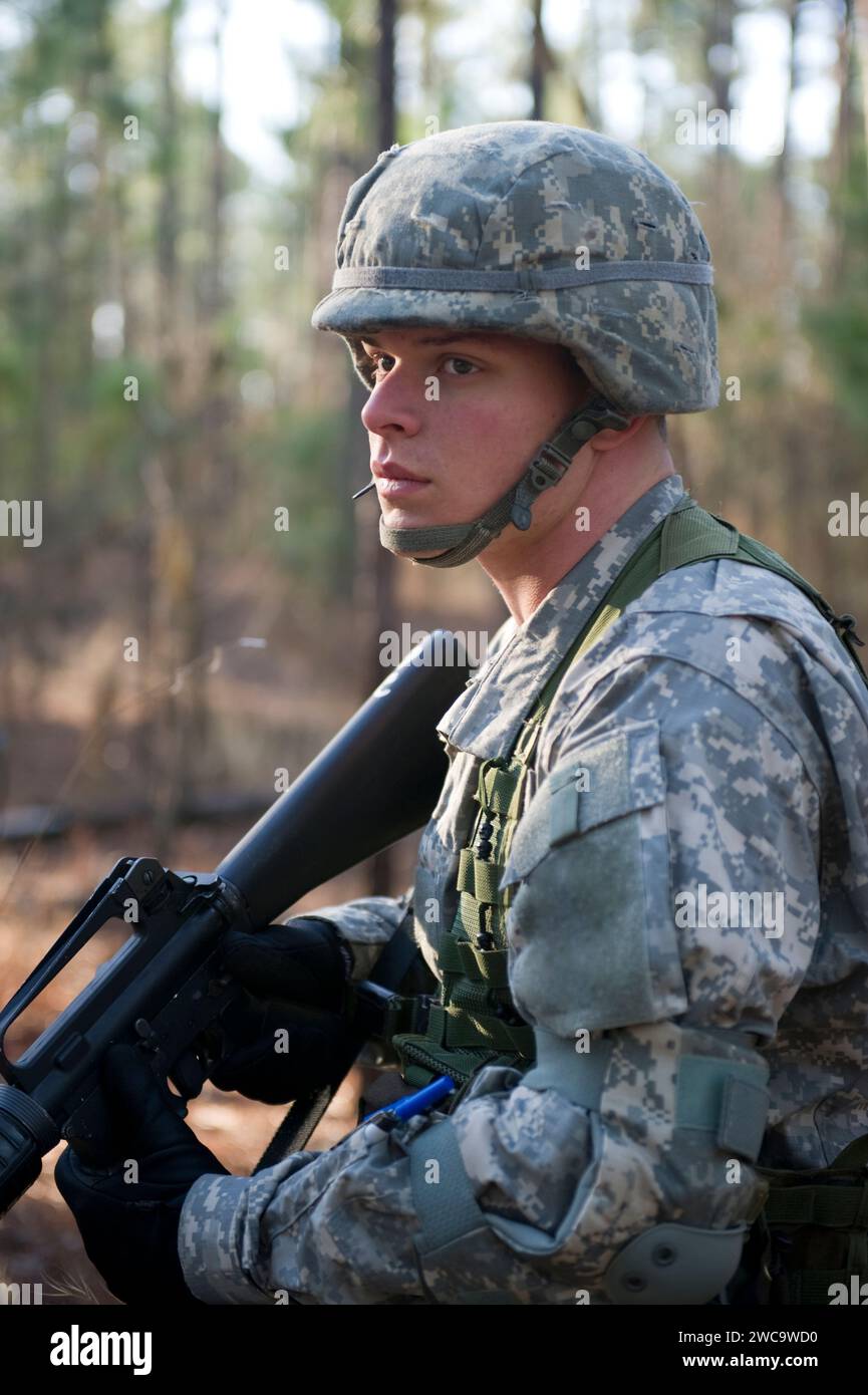 A soldier patrols through the woods during a field training exercise ...