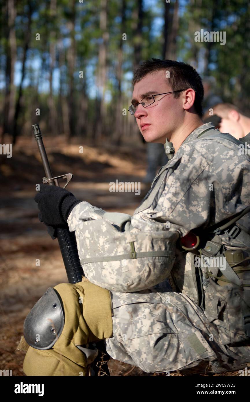 A soldier listens to his instructors while sitting on the side of a ...