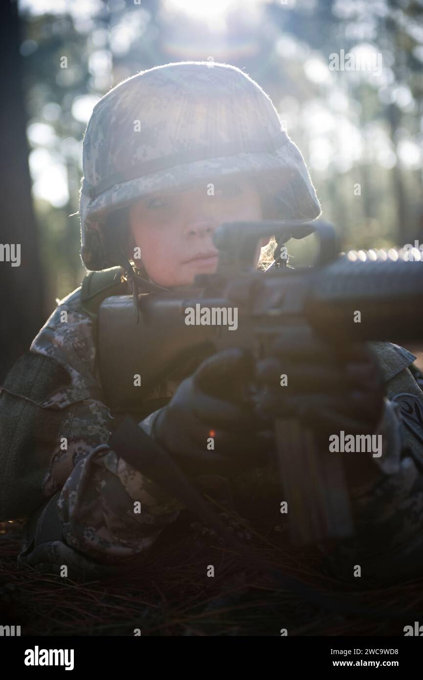 A soldier patrols through the woods during a field training exercise ...
