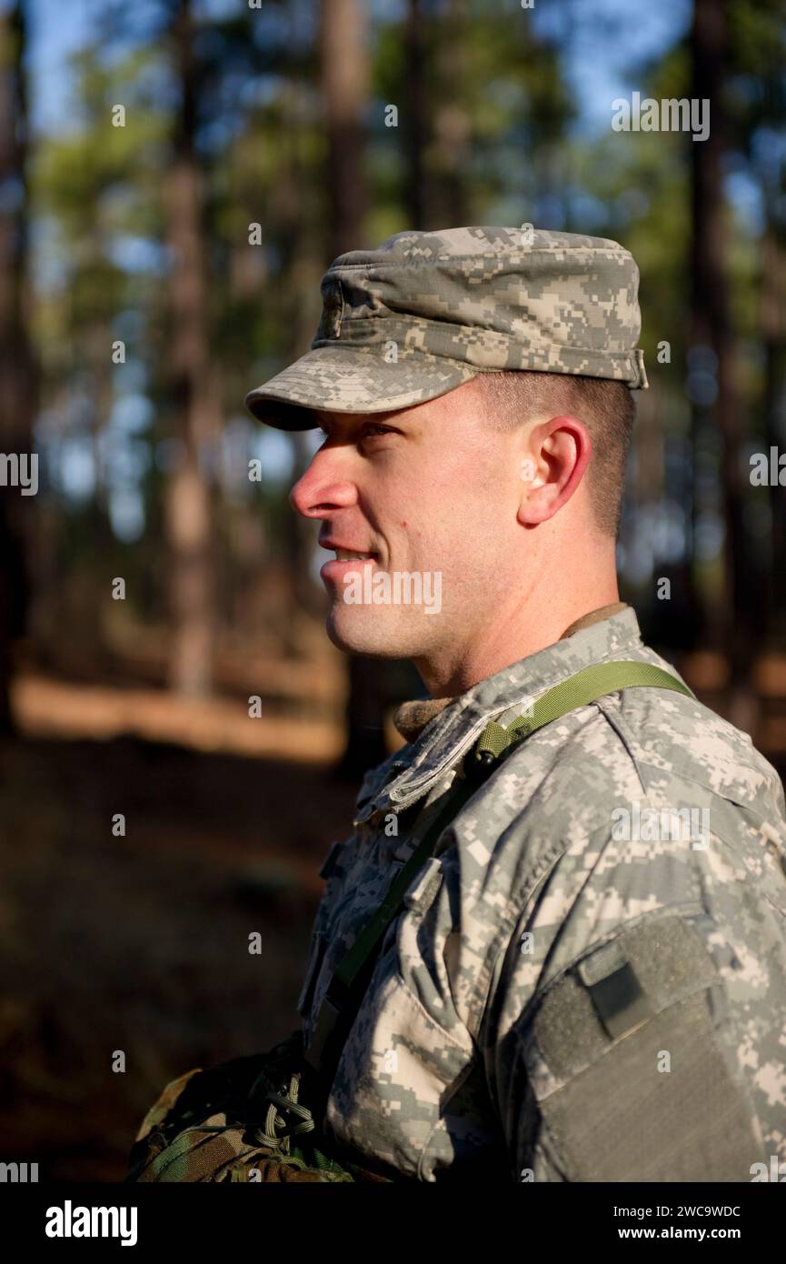 A soldier stands and instructs students during a field training ...