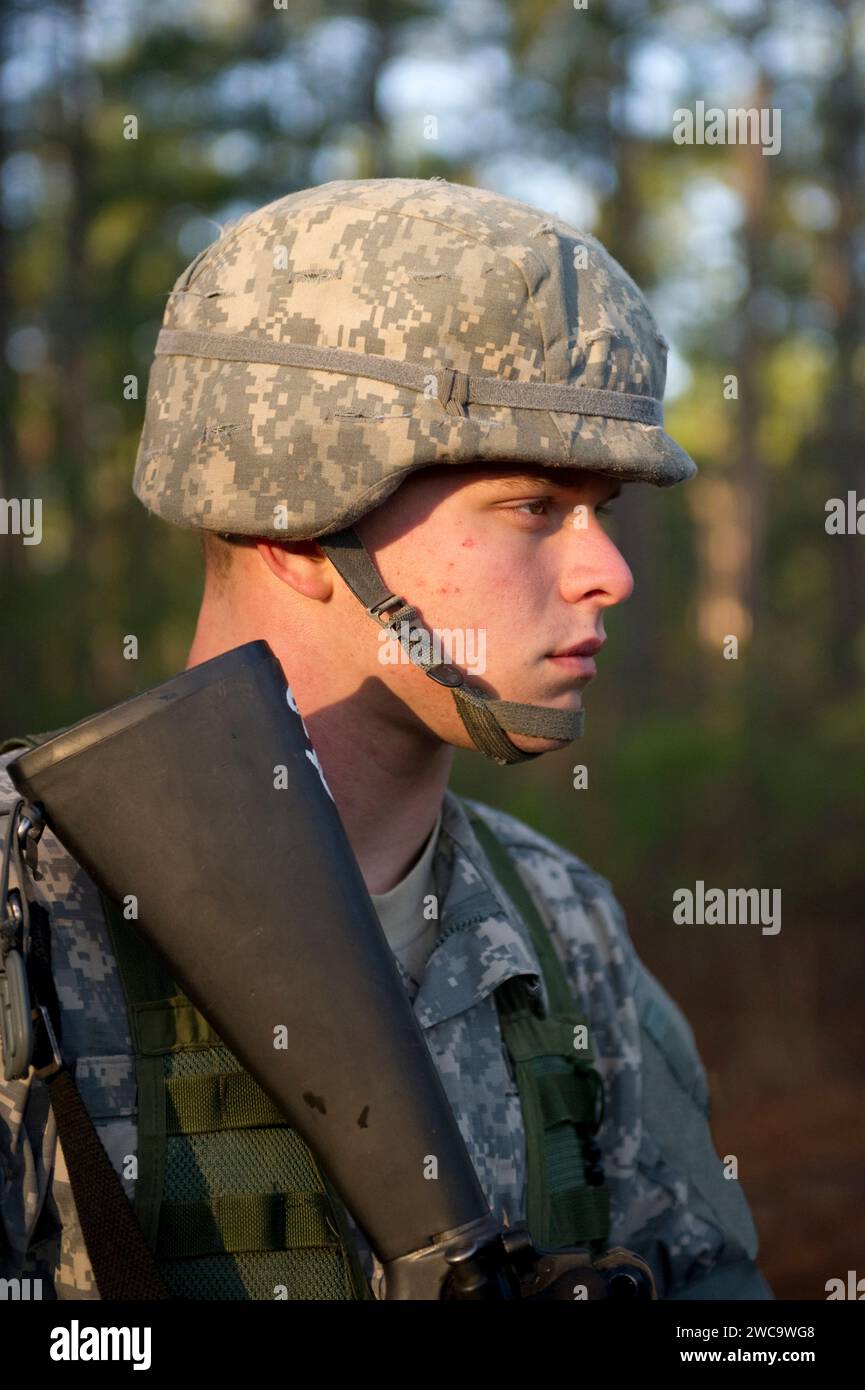 A soldier listens to his team captain during a field training exercise ...