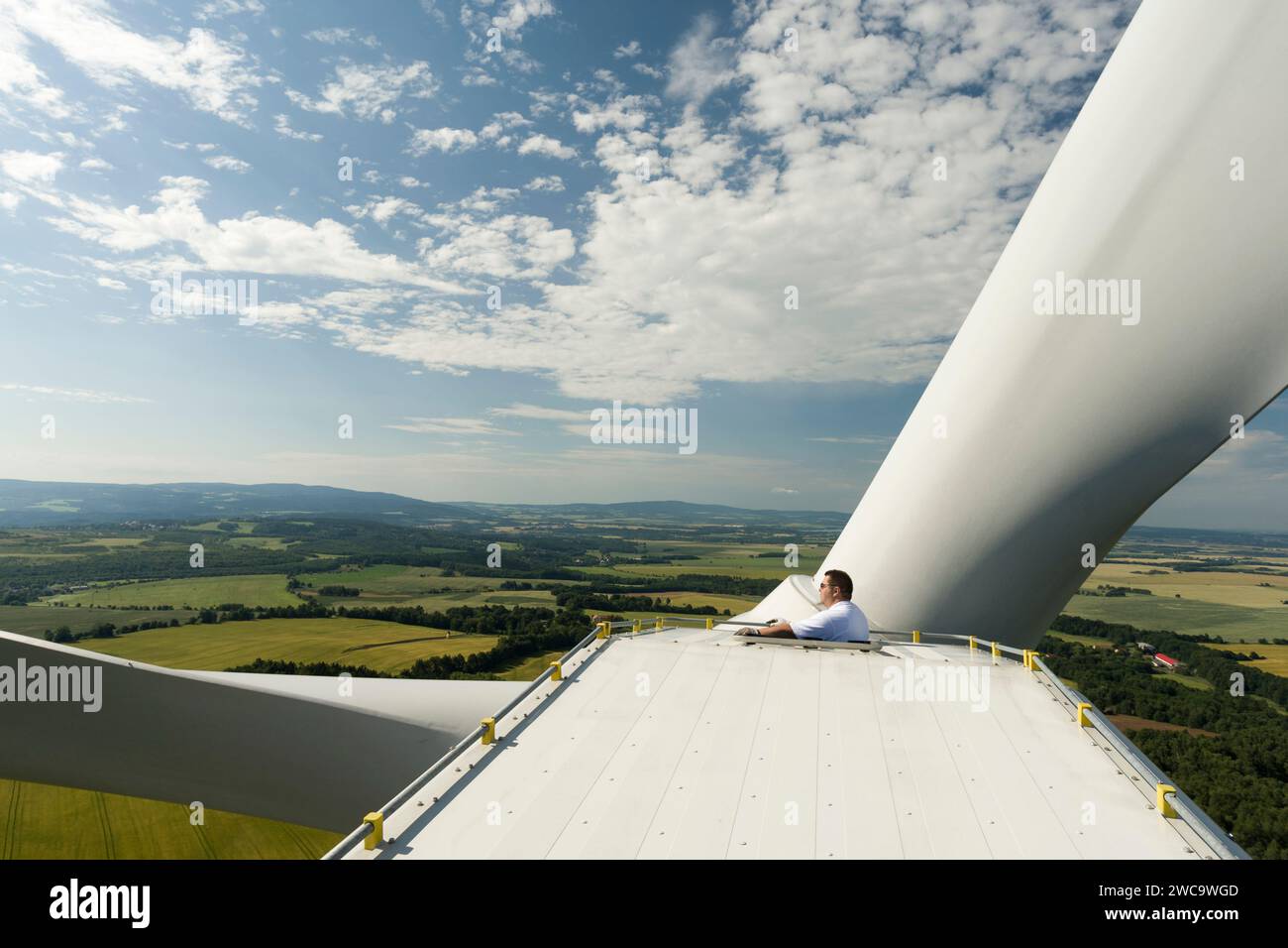 A man examines the blades of his wind turbine near Chodov, the Czech ...