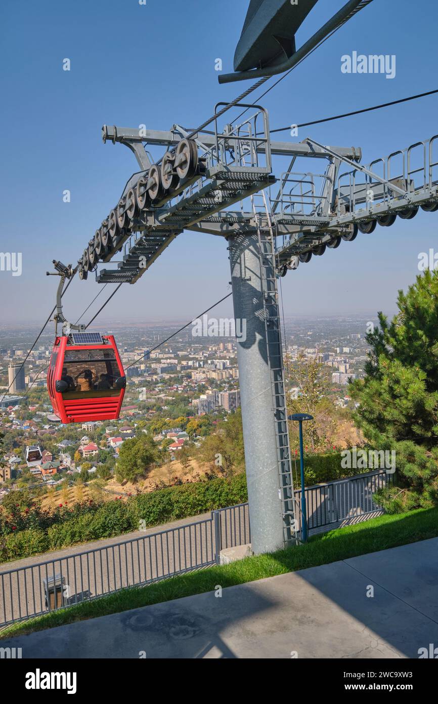 A red cable car, gondola arrives at the top station. At the mountain ...
