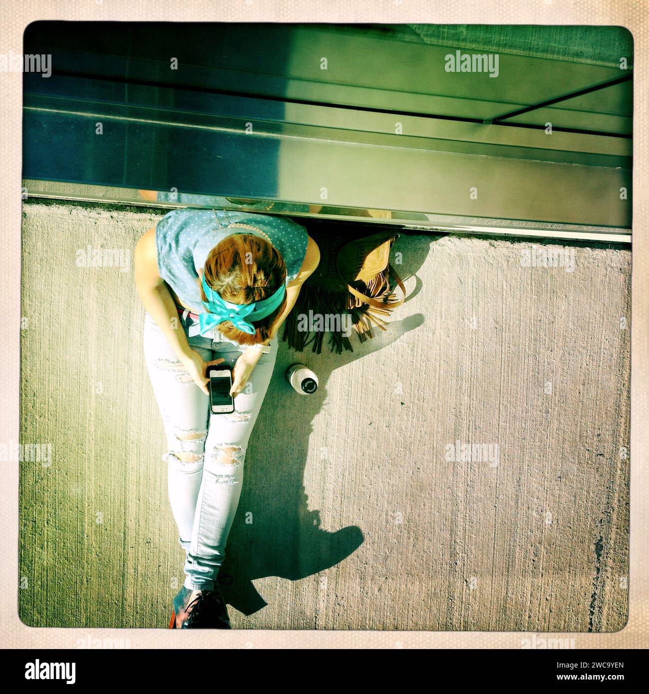 Girl Sitting on Sidewalk Texting Stock Photo - Alamy