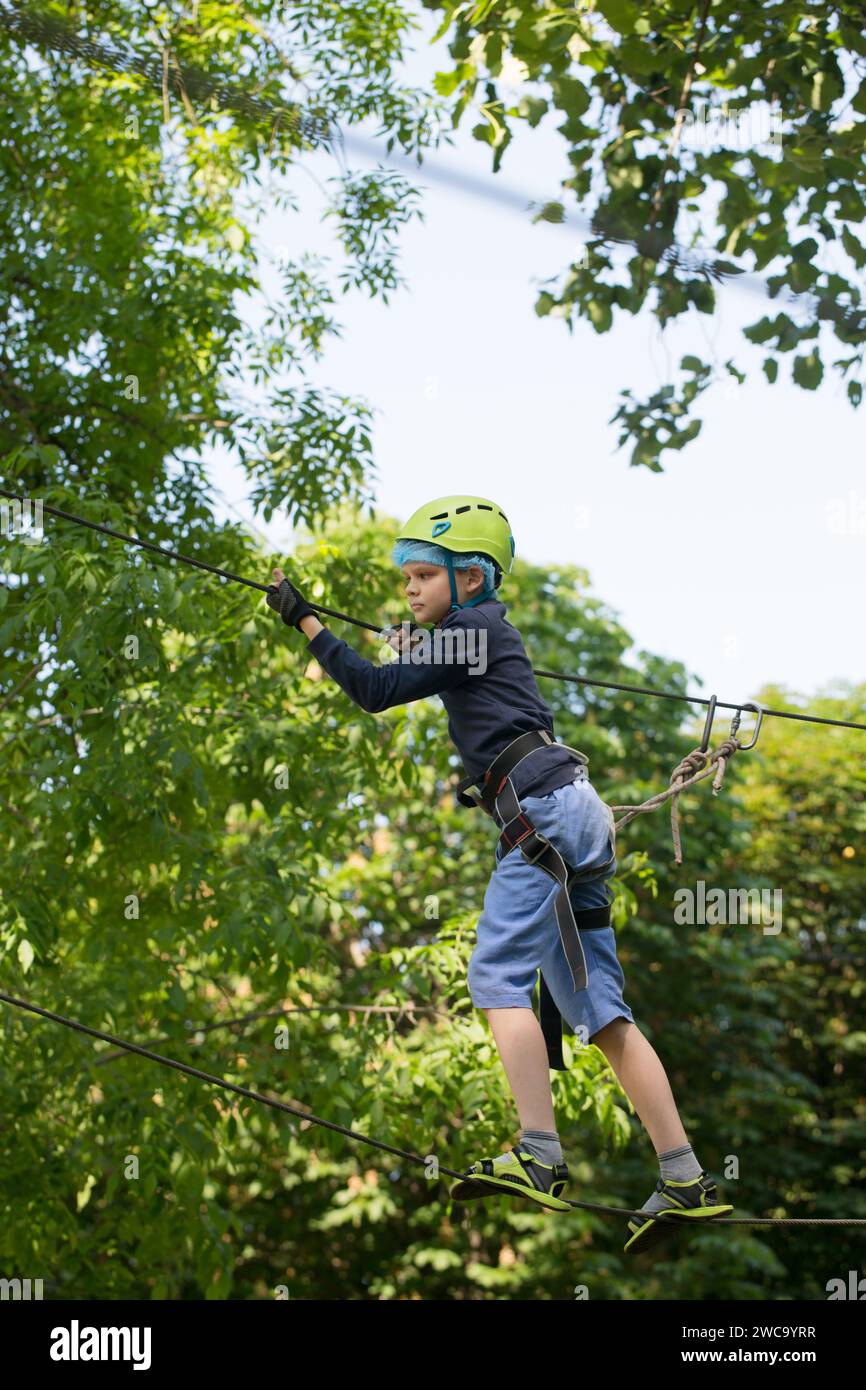 The boy walks along the rope Stock Photo - Alamy