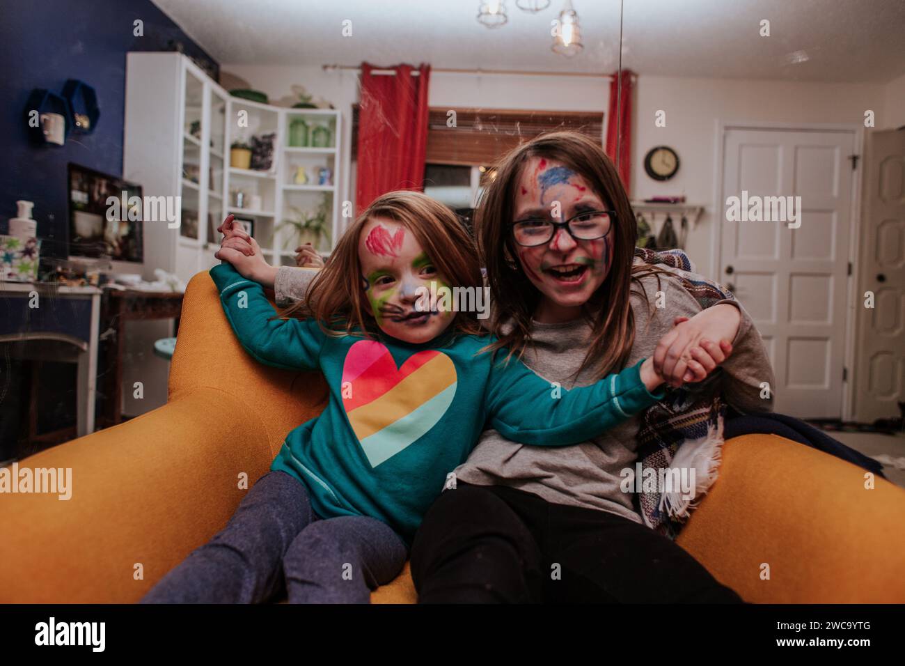 Goofy girls sitting with marker drawings on their face Stock Photo - Alamy