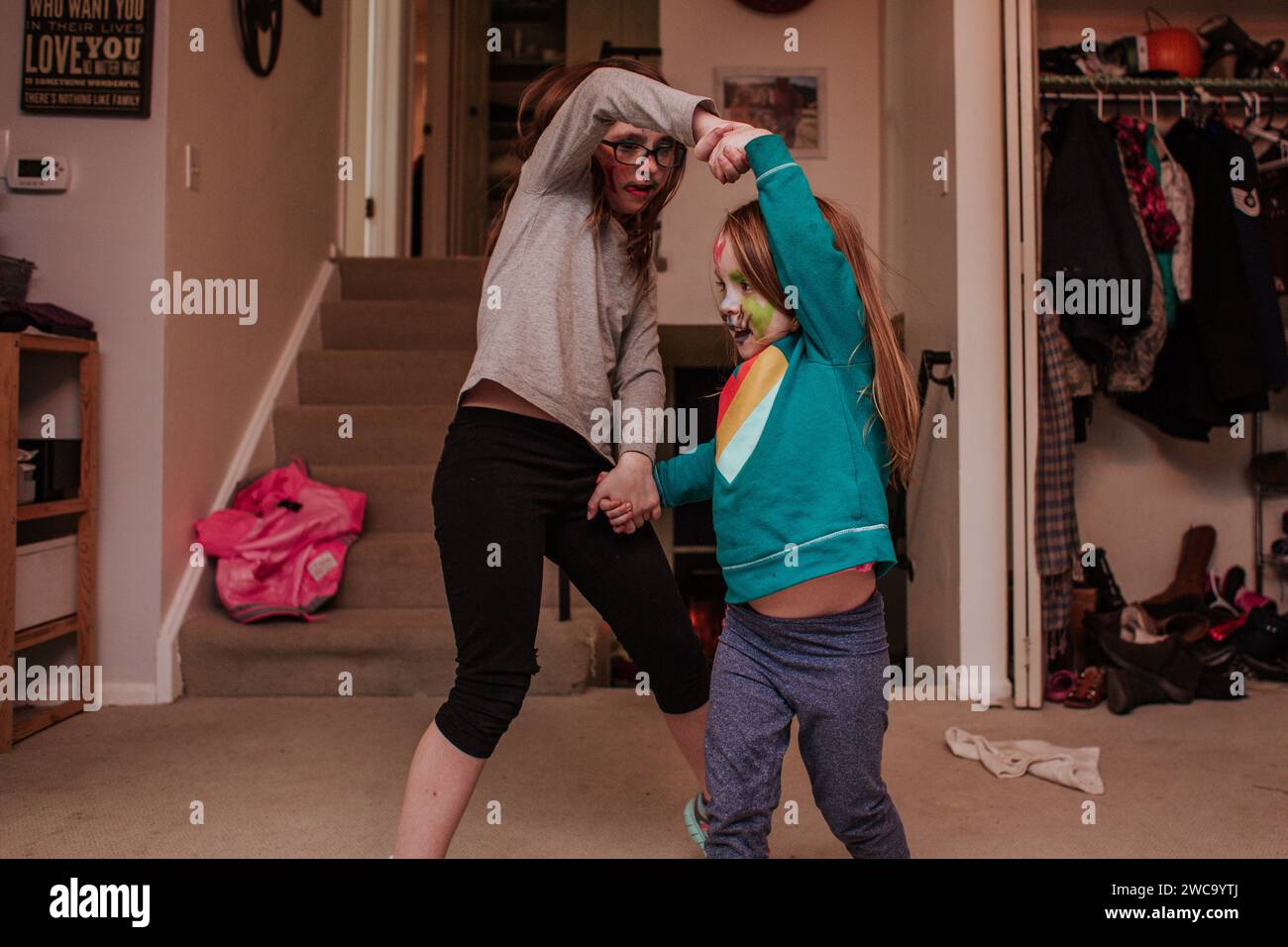girls with face paint dancing in living room Stock Photo - Alamy