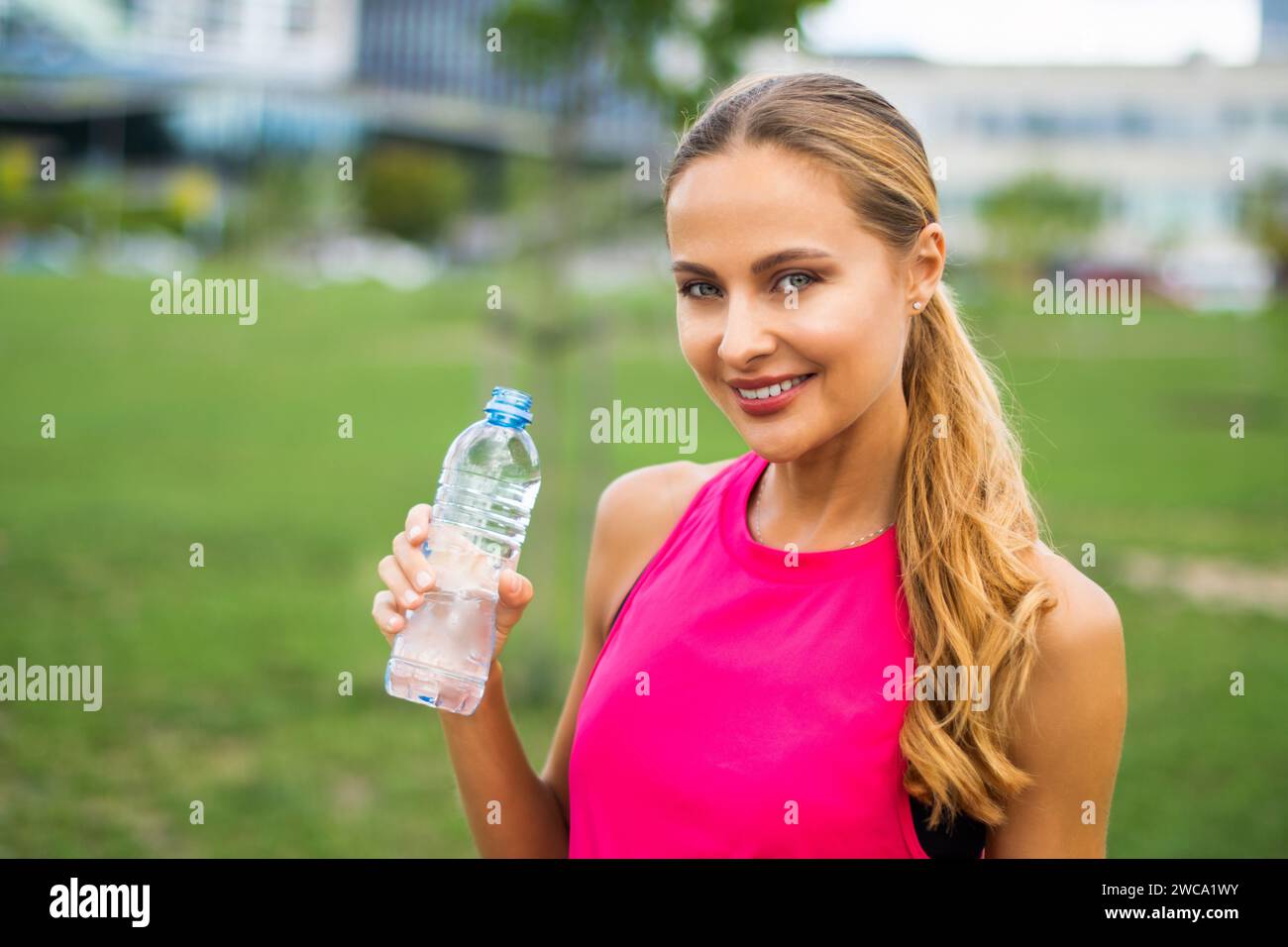 Woman drinking water after running outdoor, rehydration concept Stock ...