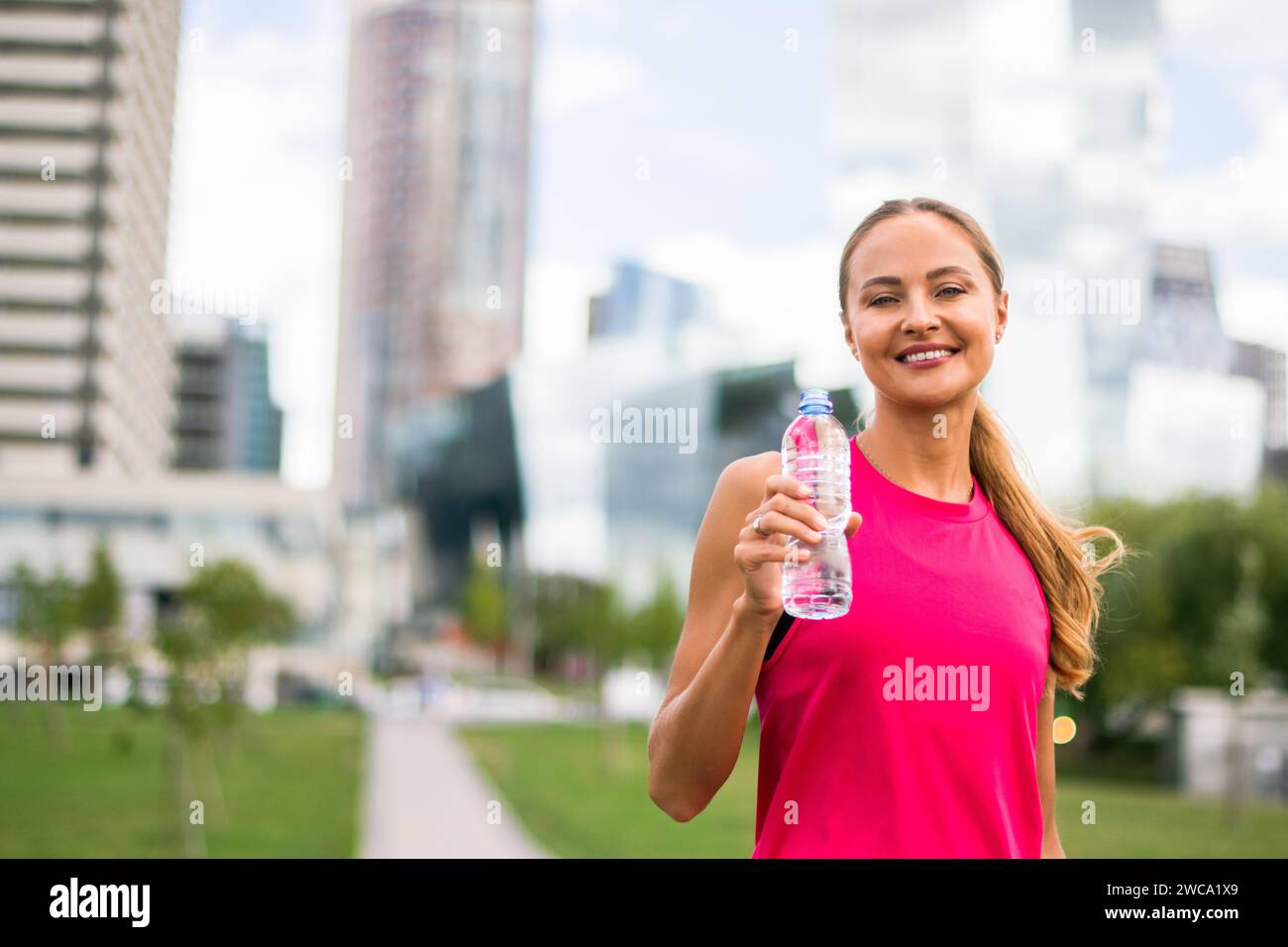 Woman drinking water after running outdoor, rehydration concept Stock ...