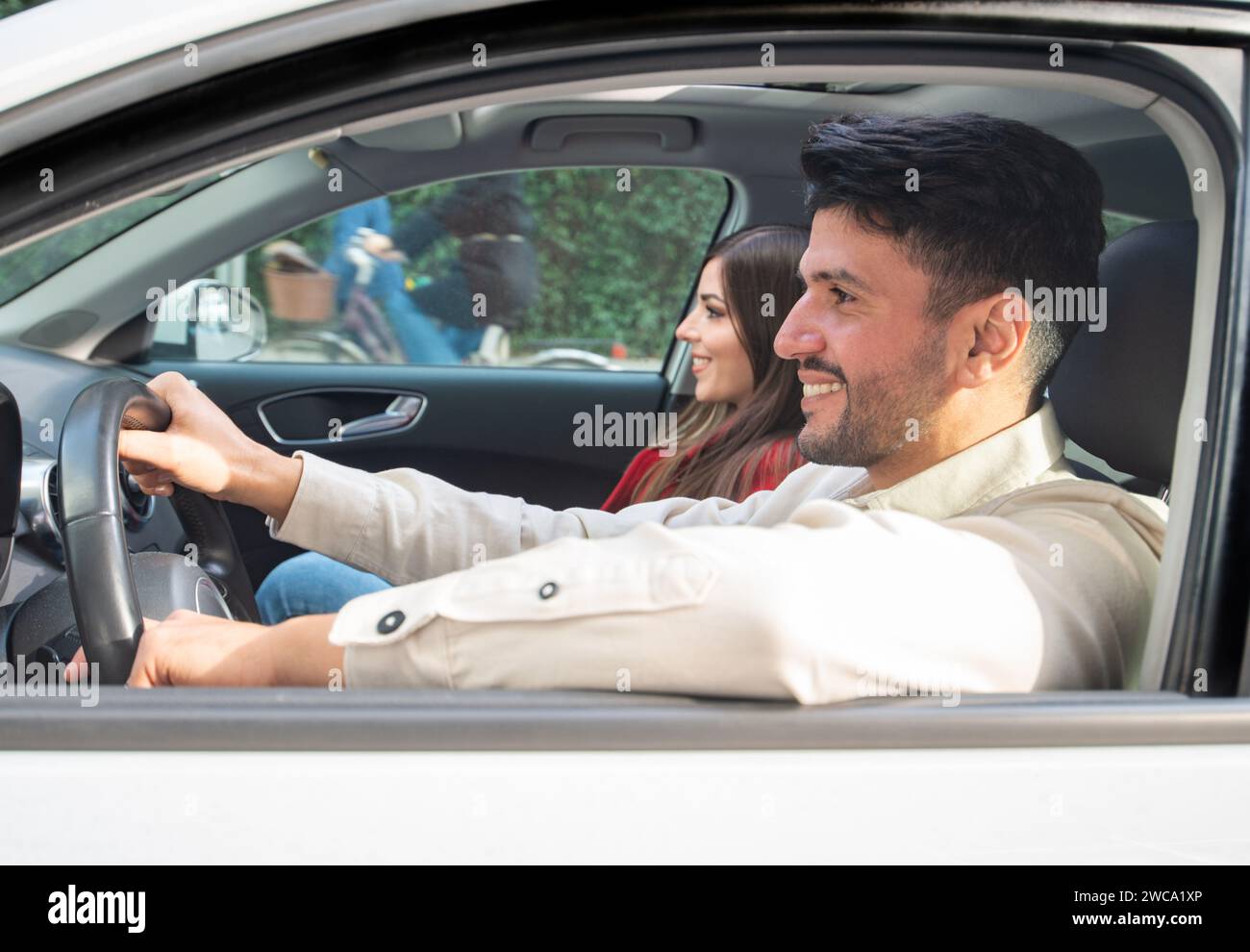 Young smiling man driving his car Stock Photo - Alamy