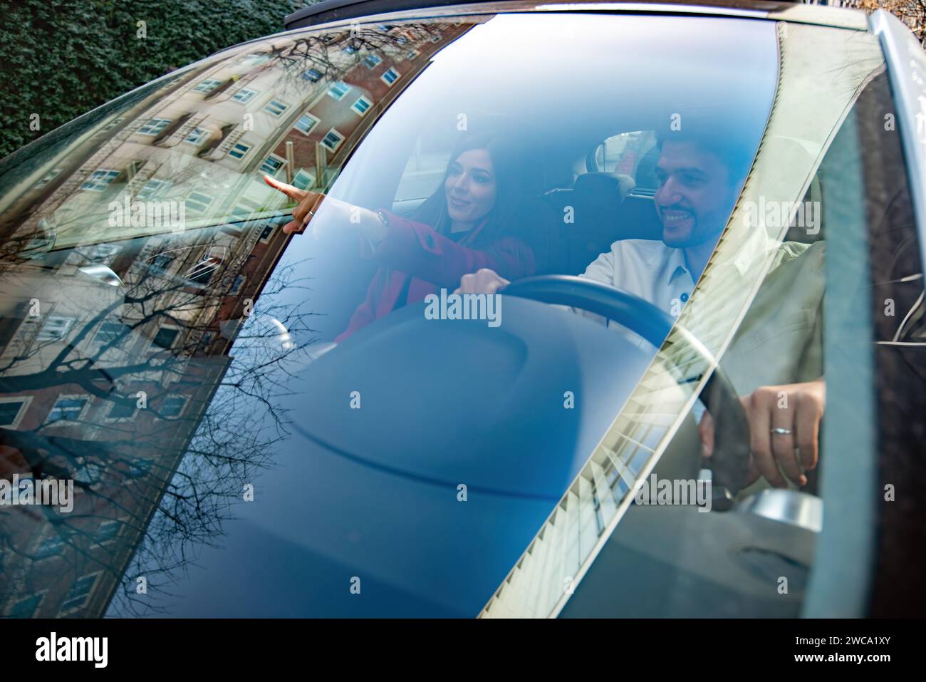 Young smiling man driving his car Stock Photo - Alamy