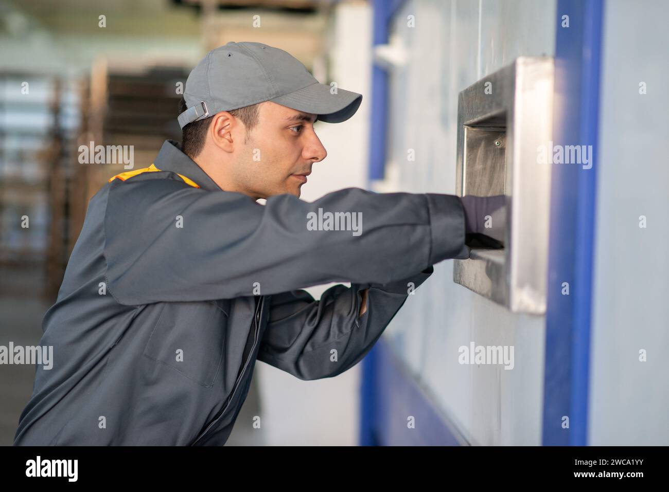 Industrial worker fixing a production machine Stock Photo - Alamy