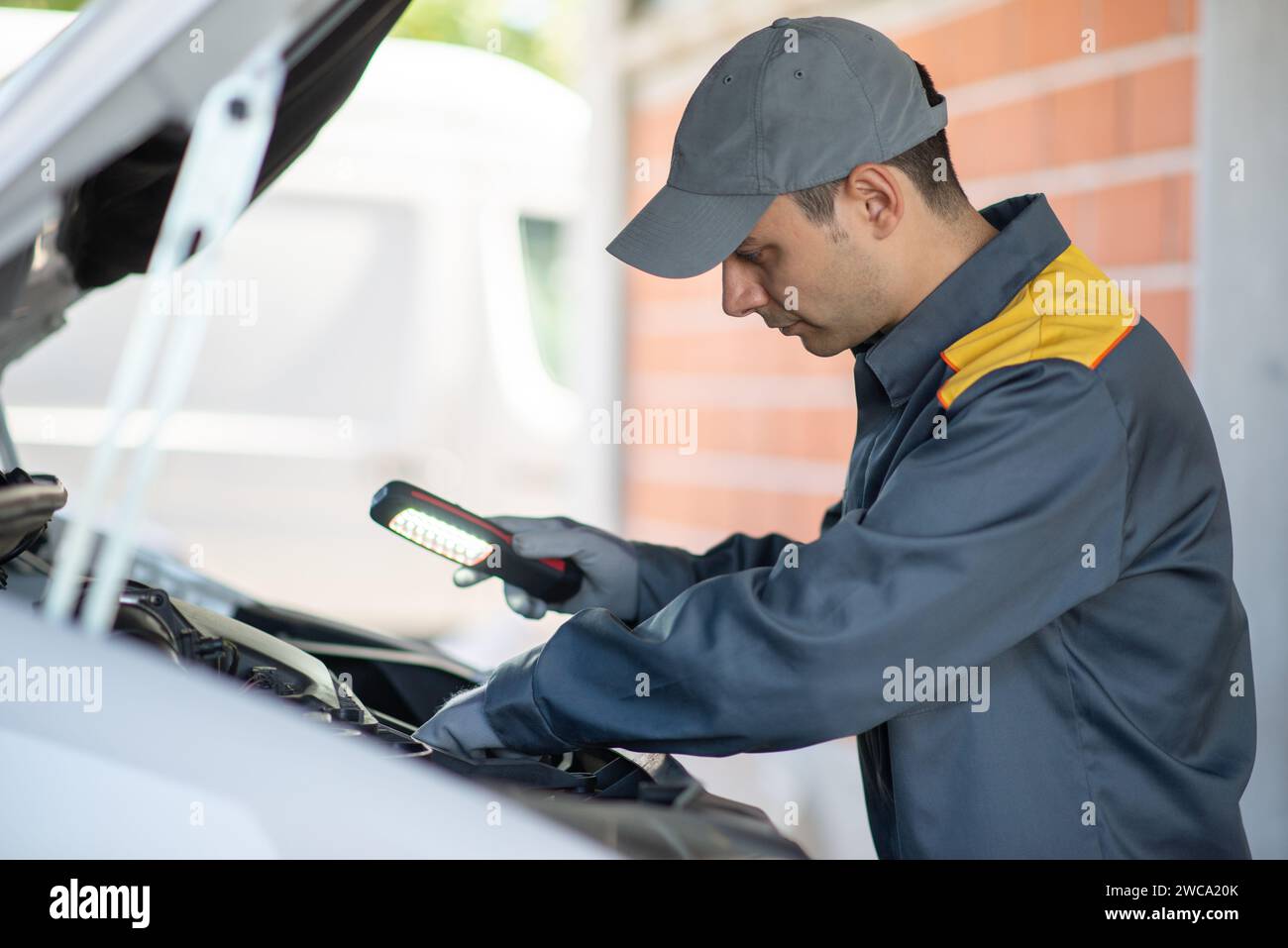 Mechainc fixing a van engine Stock Photo - Alamy
