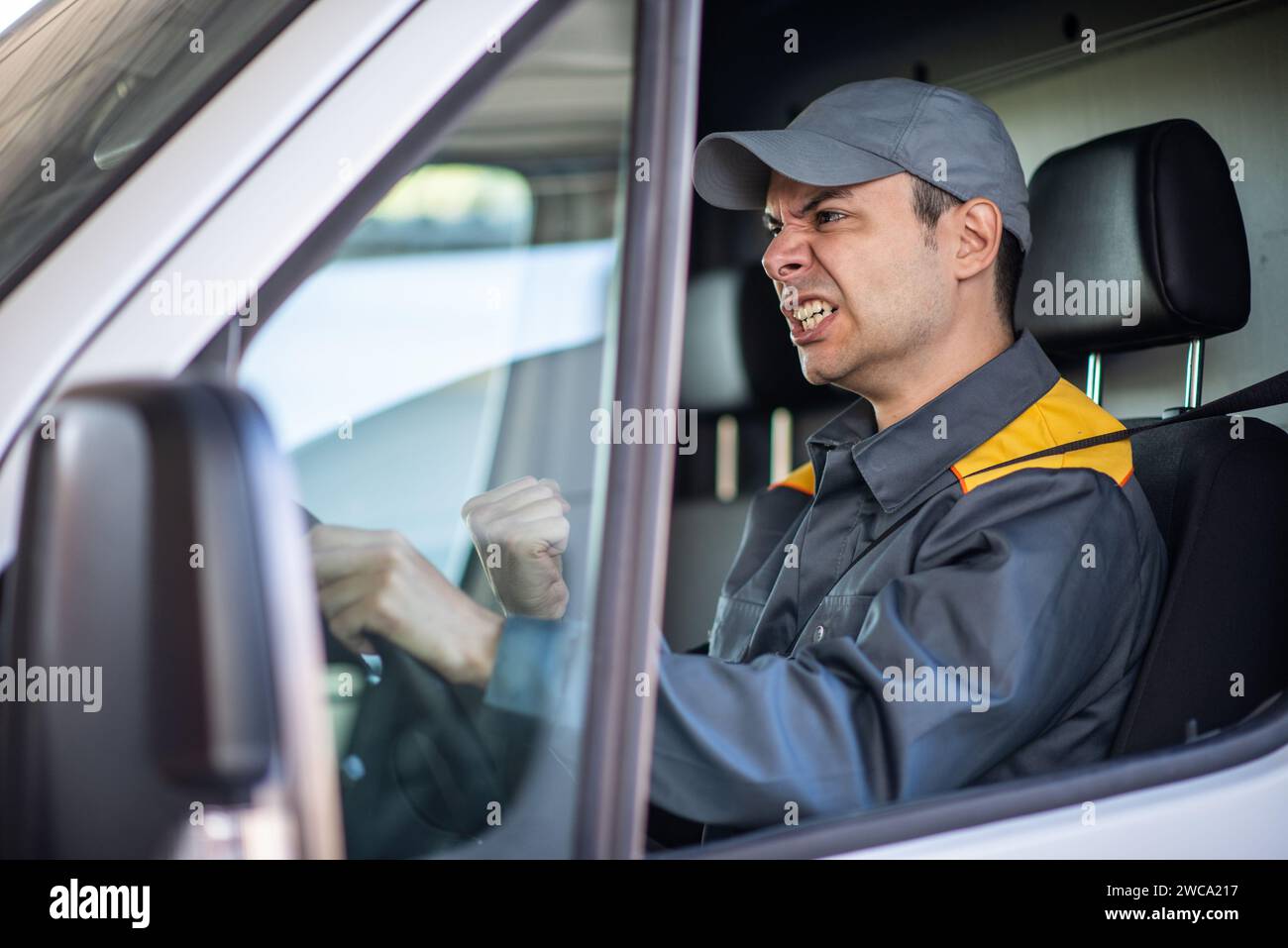 Angry frustrated delivery man in his van Stock Photo - Alamy