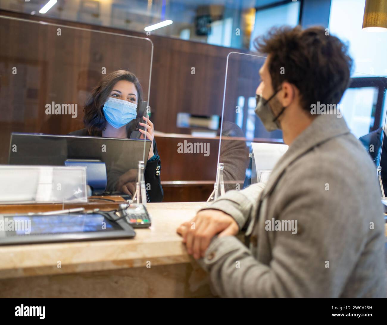 People talking in an hotel reception office Stock Photo - Alamy