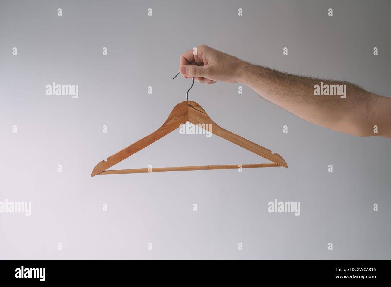 Hand holding hanger hi-res stock photography and images - Alamy