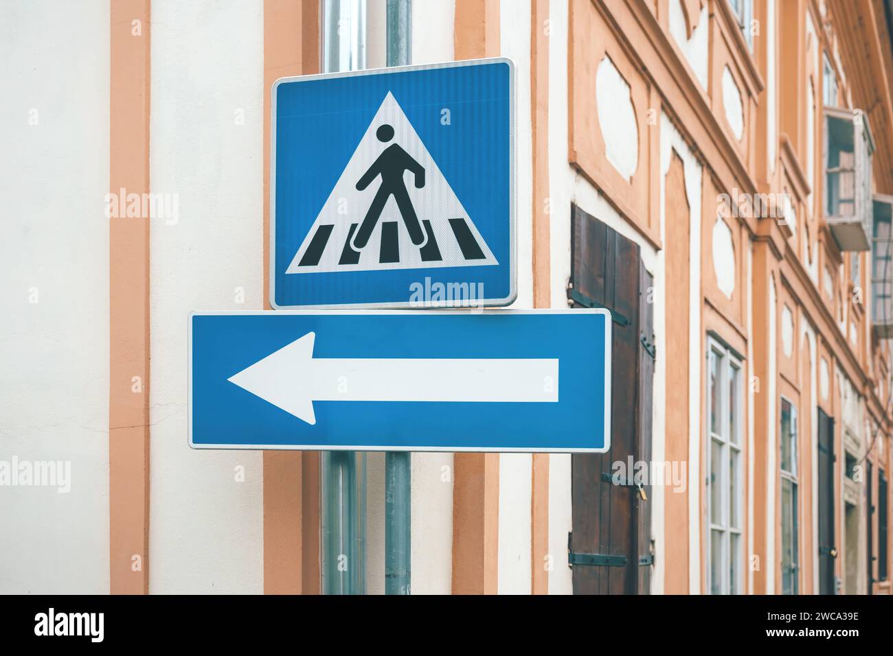 Pedestrian crossing and mandatory direction arrow road sign at the ...
