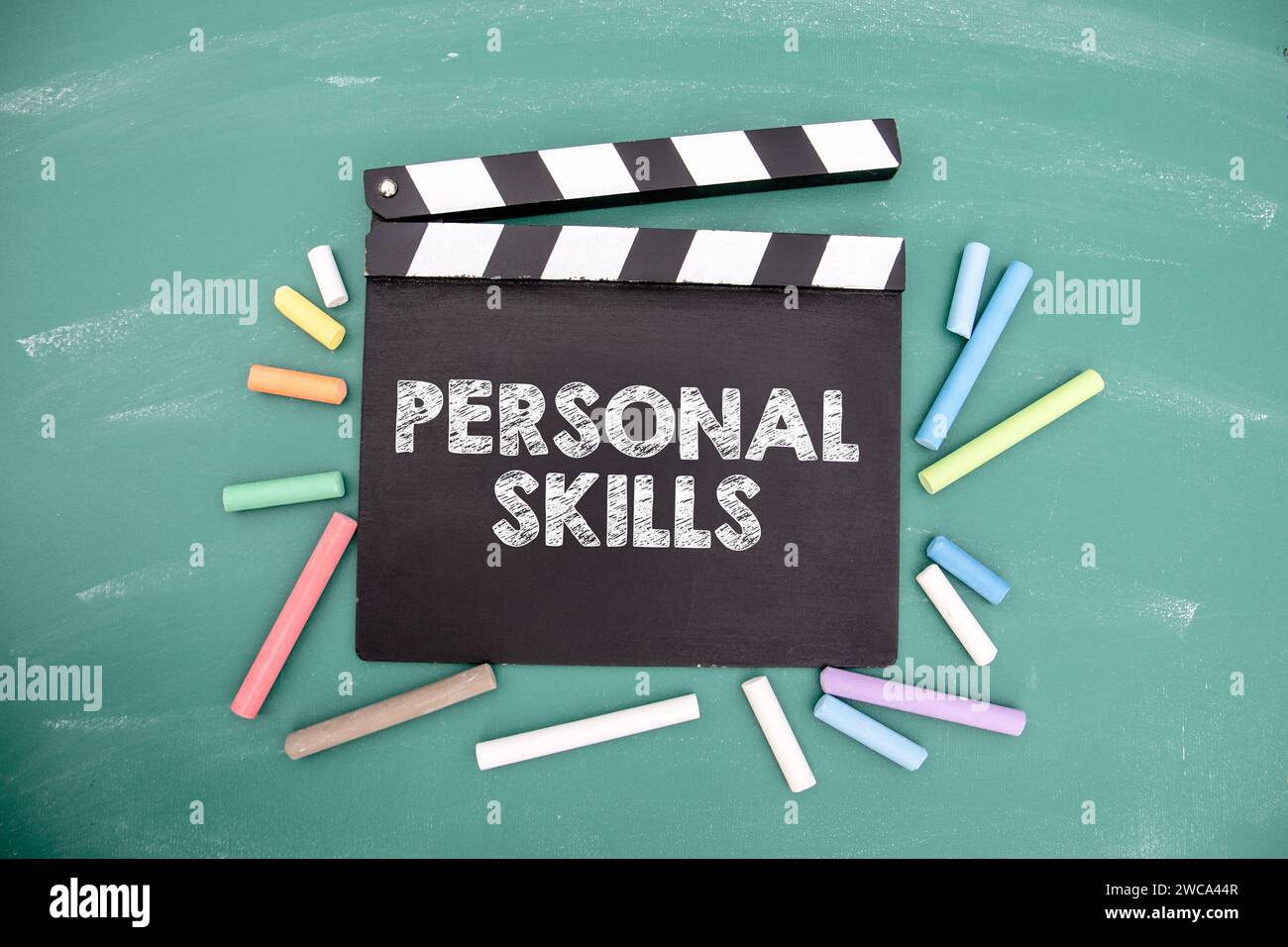 PERSONAL SKILLS Concept. Movie clapper and colored pieces of chalk ...