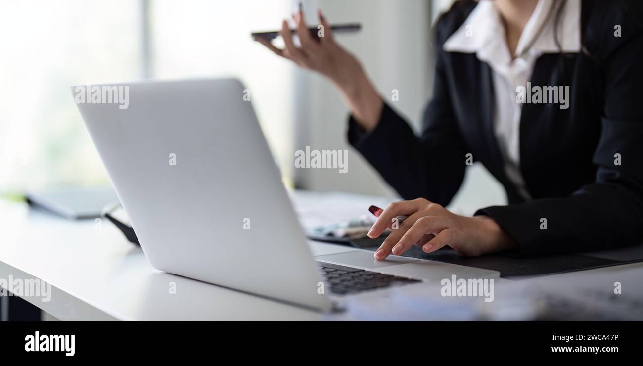 Businesswoman working using laptop computer to record and print ...