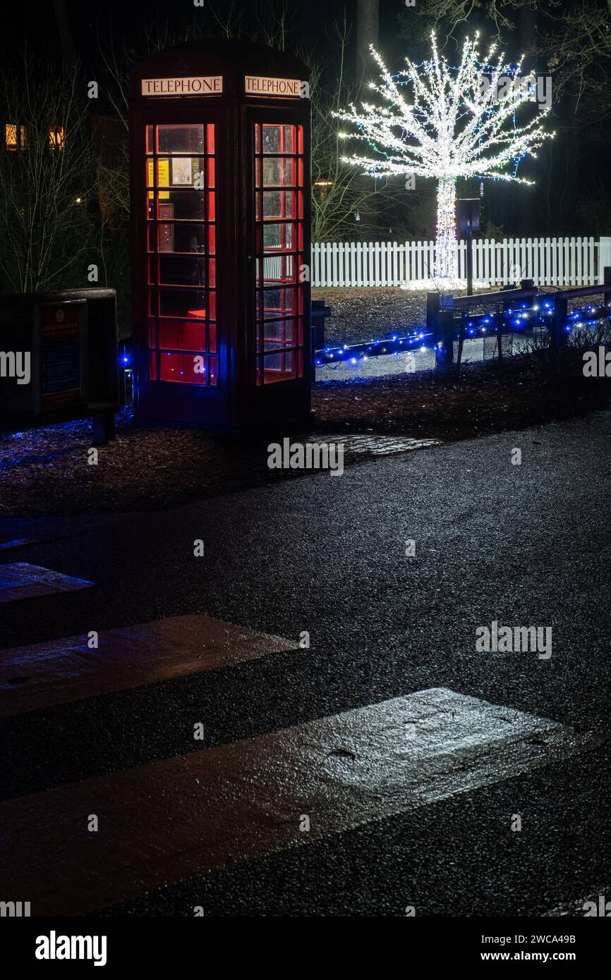 A vintage British red telephone box illuminated at night Stock Photo ...